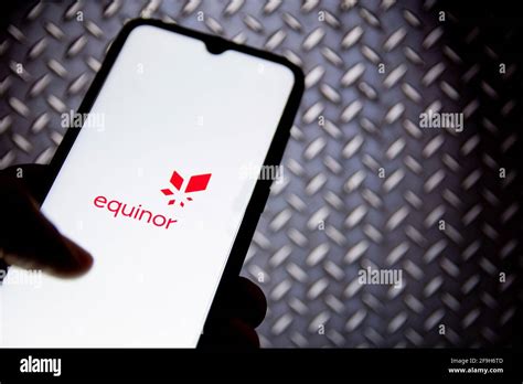 In This Photo Illustration A Equinor Logo Seen Displayed On A Smartphone Screen With A Computer