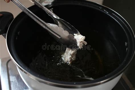 Process Of Deep Frying Breaded Crispy Chicken In Hot Oil Stock Image