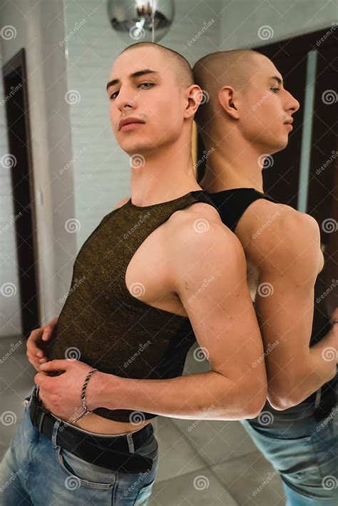 Muscular Bald Gay Man In A Croptop And His Reflection In The Mirror