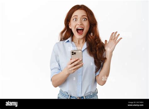 Excited Redhead Girl Screams From Amazement And Surprised Holding