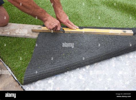Removing The Grass Free Border From The Edge Of A Sheet Of Artificial