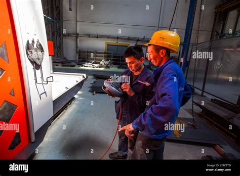 Locomotive Building Plant Two Asian Workers Programming CNC Machine Stock Photo Alamy