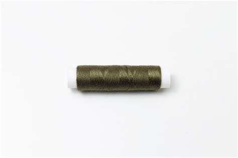 Premium Photo Closeup Of Dark Green Thread Spool Isolated On White Background