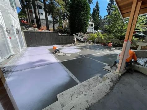Sand Finish Concrete Driveway With Custom Stained Compass Inlay In