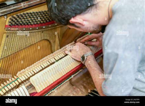 Piano Tuning Process Closeup Of Hand And Tools Of Tuner Working On
