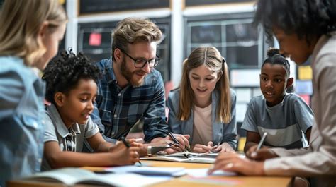 A Teacher And Students Working Together In A Classroom Premium Ai