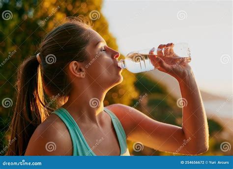 Hydration Is An Important Part Of Running An Attractive Young Woman Getting A Drink During Her