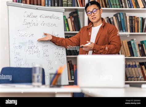 Asian Teacher Teaching Online Having Remote Class Standing At Workplace