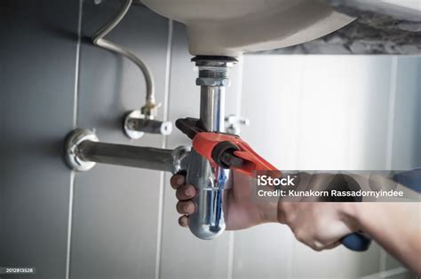 Plumber Uses Wrench To Repair Water Pipe Under Sink There Is
