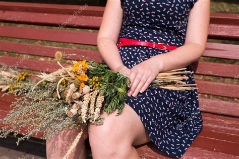 Young Woman Sitting With Motley Grass Bouquet During Macovei Cel
