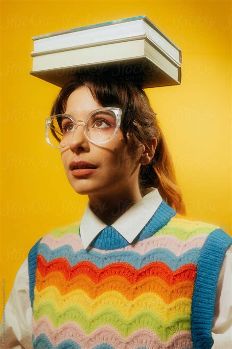 Nerdy Woman While Holding Two Books On Her Head By Stocksy Contributor Thais Ramos Varela