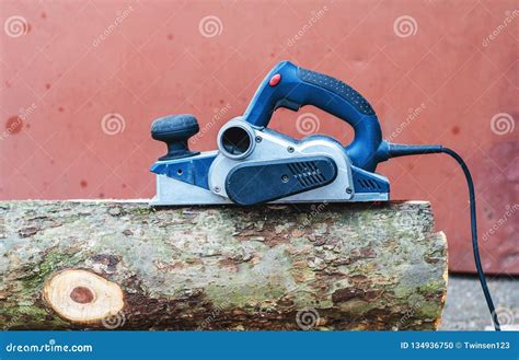 Manual Electric Plane On A Raw Tree Log Woodwork Manufacture Of Wood Products Carpentry