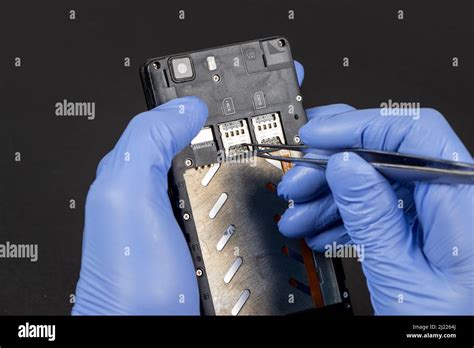 Process Of Mobile Phone Repair Hands Of A Service Worker Repairing Modern Mobile Phone Stock