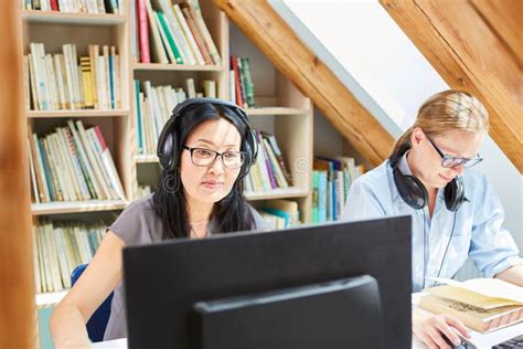 Two Women Using E Learning On The Computer Stock Photo Image Of Community Project 184563256
