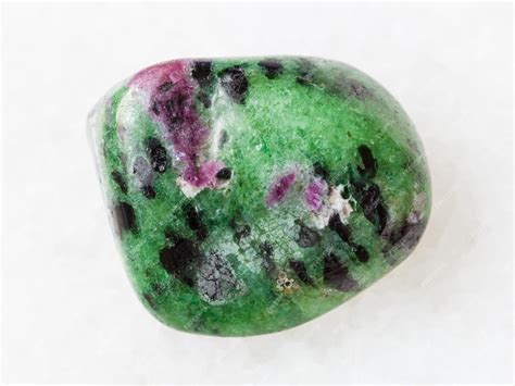 Premium Photo Polished Zoisite Anyolite Gemstone On White