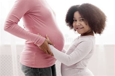 Cute Little Afro Girl Hugging Her Pregnant Mom S Tummy and Smiling Stock Image - Image of happy ...