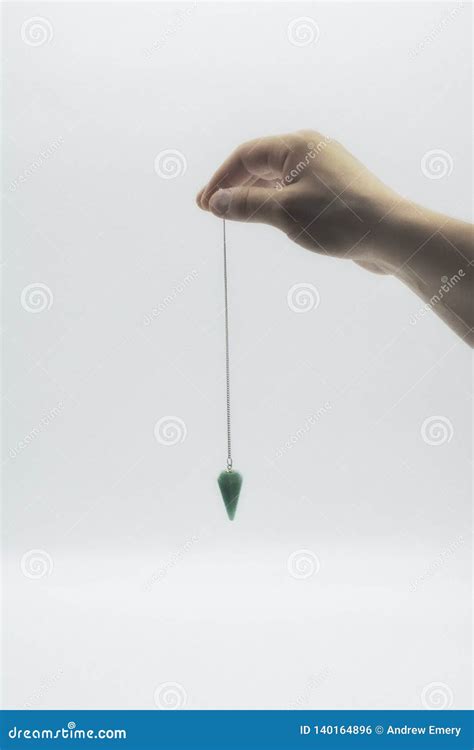 Pendulum Dowsing On An Isolated White Background With A Turquoise Crystal Royalty Free Stock