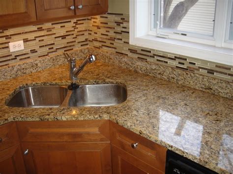 Giallo Ornamental Granite Countertop And Matching Glass Backsplash