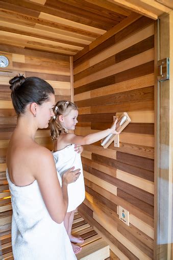Mom And Daughter Control The Time Spent In The Sauna Enjoying Time