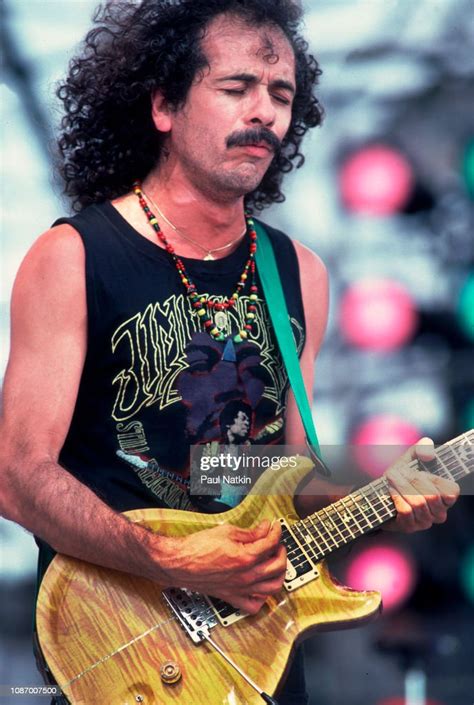 Carlos Santana Performs On Stage At Live Aid At Veterans Stadium In