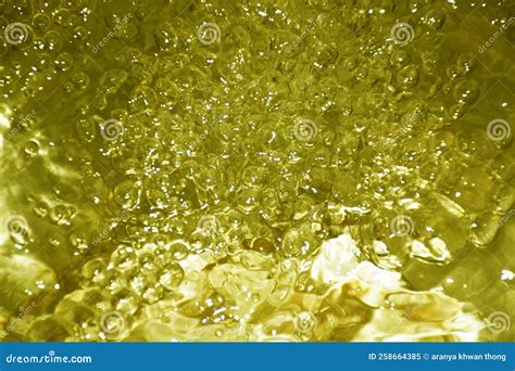 Clear Golden Yellow Water With Bubbles For Design And Background Stock