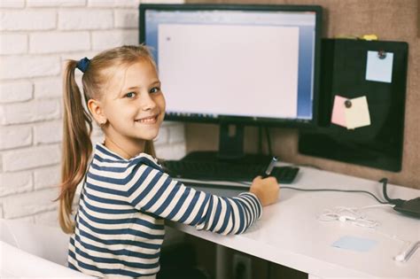 Premium Photo The Schoolgirl Sits At The Computer And Does Her