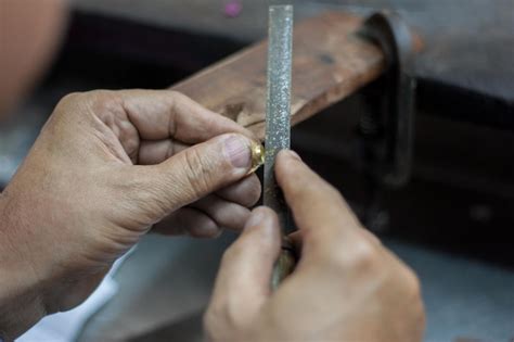 Premium Photo Cropped Image Of Jeweler Shaping Ring With Rasp In Workshop
