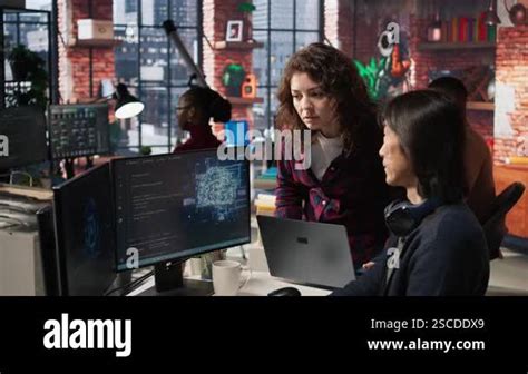It Engineers Cooperating In Ai Focused Startup Debugging Applications Crosschecking Between Pc