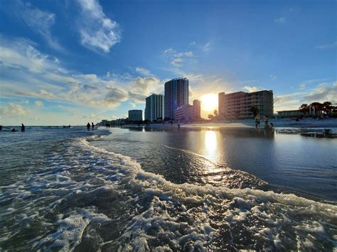 A Beach With Buildings In The Background Photo Free Building Image On