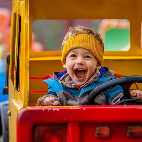 A Young Boy In A Yellow Hat Is Riding A Red Car Premium Ai Generated