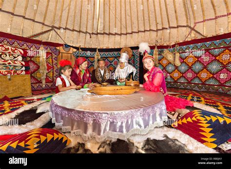Kazakh People In Traditional Costumes In A Nomadic Tent Known As Yurt