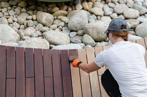 Manual Worker Female Stain A Deck Wood With A Brush Stock Image Image