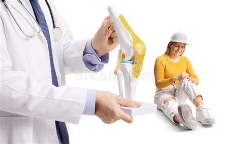 Girl With Knee Injury And Doctor With A Knee Bone Model Stock Image