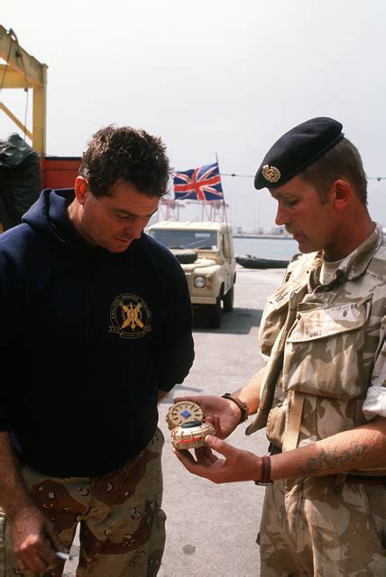 A Member Of Explosive Ordnance Disposal Eod Mobile Unit One Confers With A Member Of A British