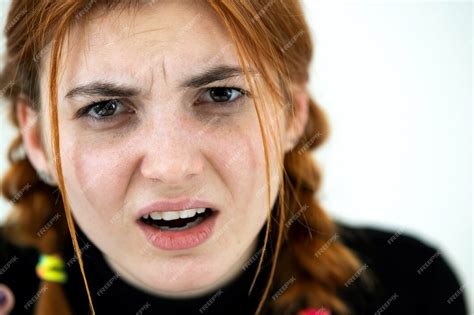 Premium Photo Portrait Of A Confused Redhead Teenage Girl