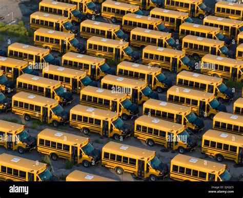 A High Aerial Photo Above A Parking Lot With Rows Of Yellow School
