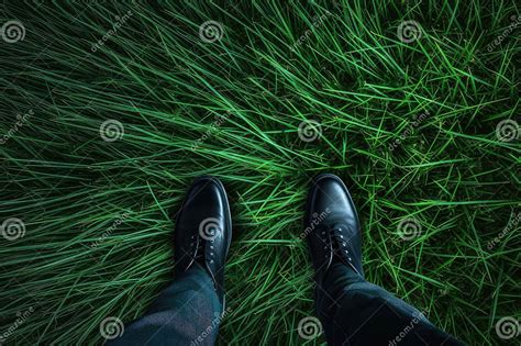 Feet In Shoes In Grass In Dark Gray And Emerald Style Stock Image