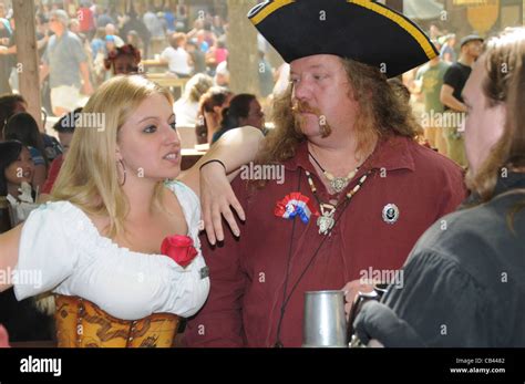 3 People Dressed In Medieval Costumes Talk At The Renaissance Festival