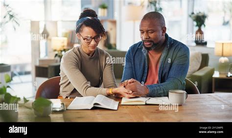 Couple Holding Hands And Praying With Bible For Religion Or Spiritual