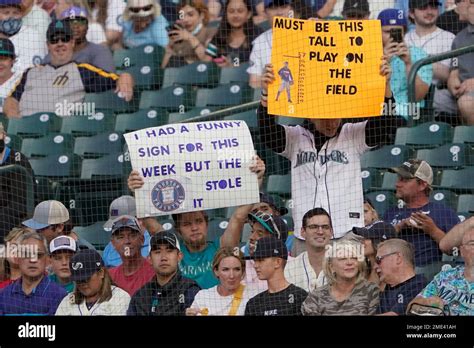 Seattle Mariners Fans Hold Signs Mocking The Height Of Houston Astros