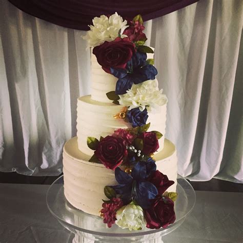 Navy And Burgundy Wedding Cake With Beautiful Floral Accents