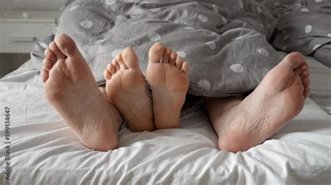 Loving Couples Feet Under The Blanket Expressing Their Love And