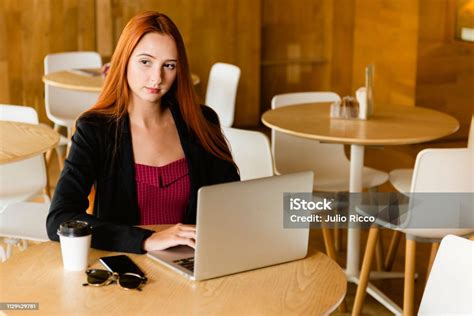 Beautiful Redhead Model Using Computer Cellphone Sunglasses And Coffee