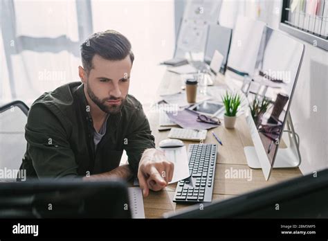 selective focus of data analyst pointing on computer monitor while