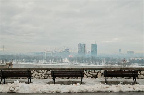 Winter City Skyline Of Belgrade With River Benches And Snowy Promenade