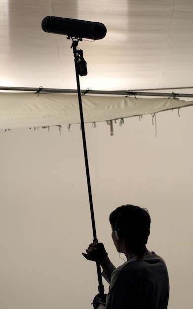 Premium Photo Boom Microphone Hold Up High By Video Or Film