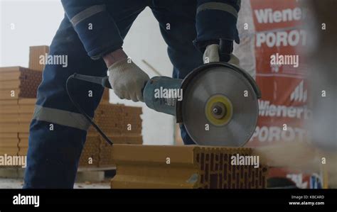 Worker Cutting Bricks Brick Cut With Circular Saw Or Grinder Stock