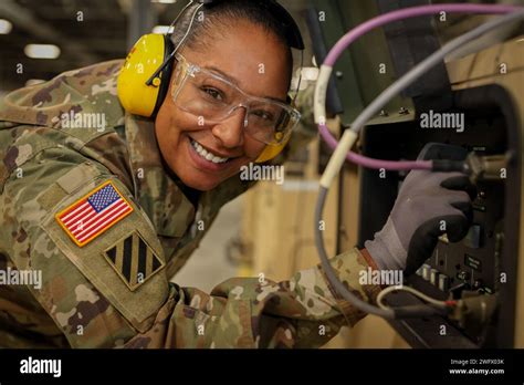 Staff Sgt Jasmine N Barnes Smiles At The Camera While Working On A