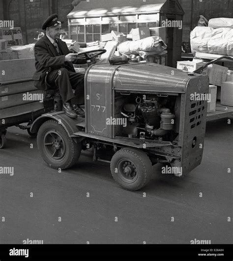 1950s Historical A Uniformed Briitsh Railways Porter On The Concourse