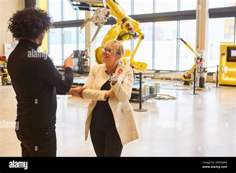 two engineers engaging in conversation about robotics innovations in a